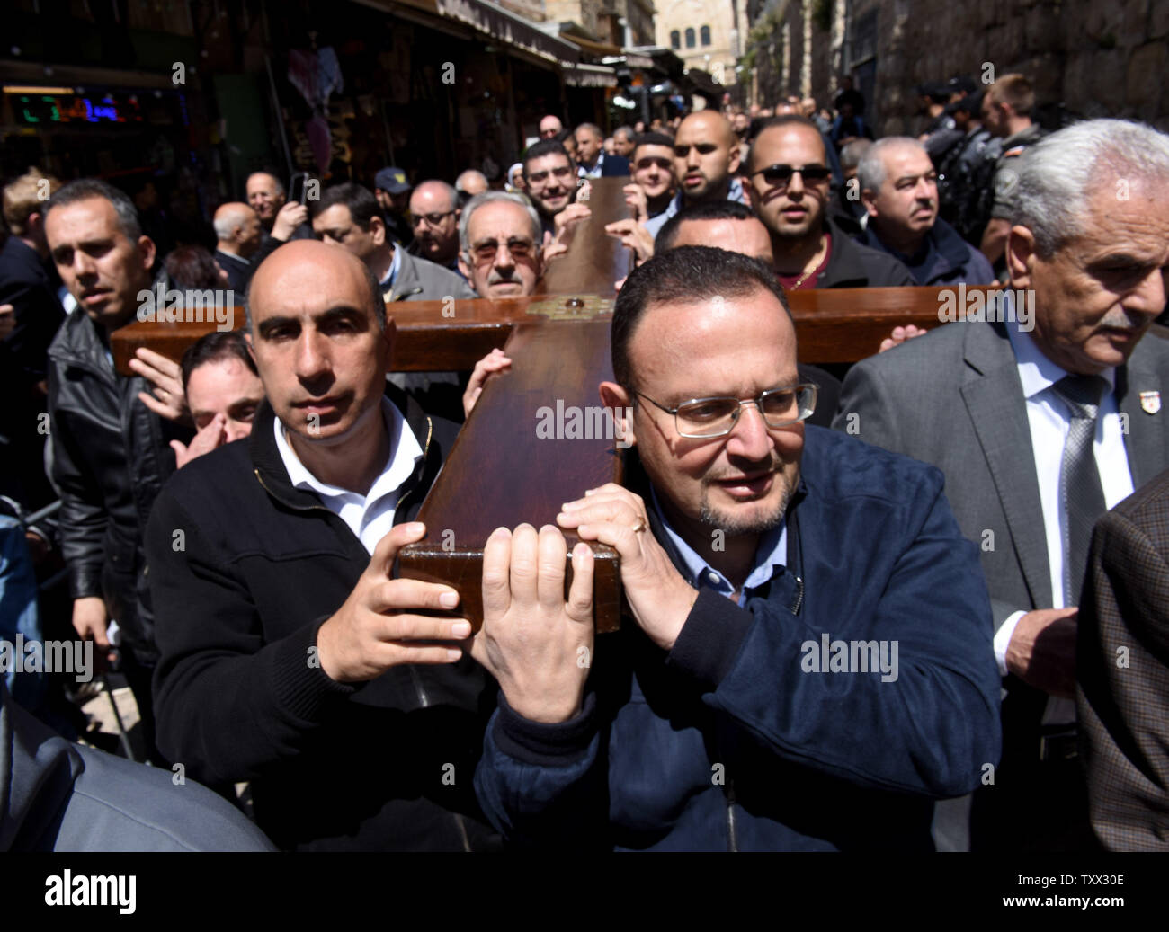 Palestinian Christians carry a cross on the Via Dolorosa, the Way of ...
