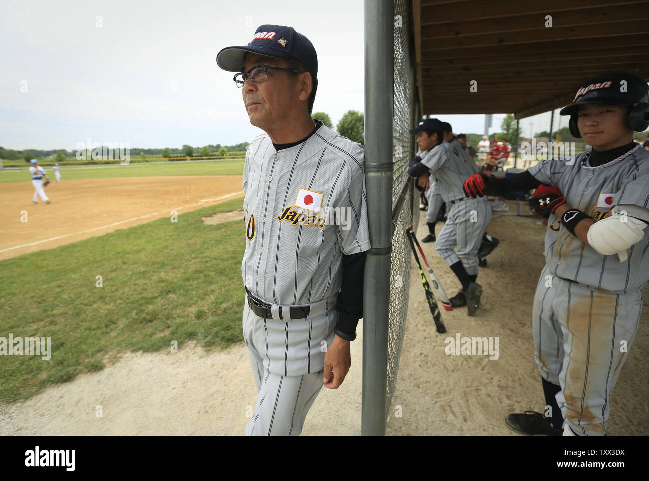 Japan coach Sadao Nakashiro (L) watches from the bench as his team ...