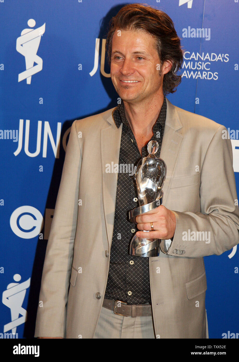 Blue Rodeo Band member Jim Cuddy holds his Group of the Year Award ...
