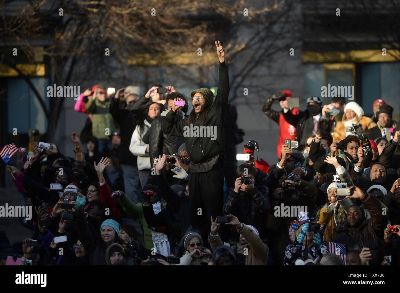 A man cheers as U.S. President Barack Obama's motorcade drives the ...