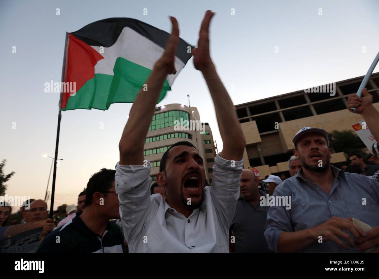 Amman, Jordan. 25th June, 2019. People shout slogans voicing rejection ...