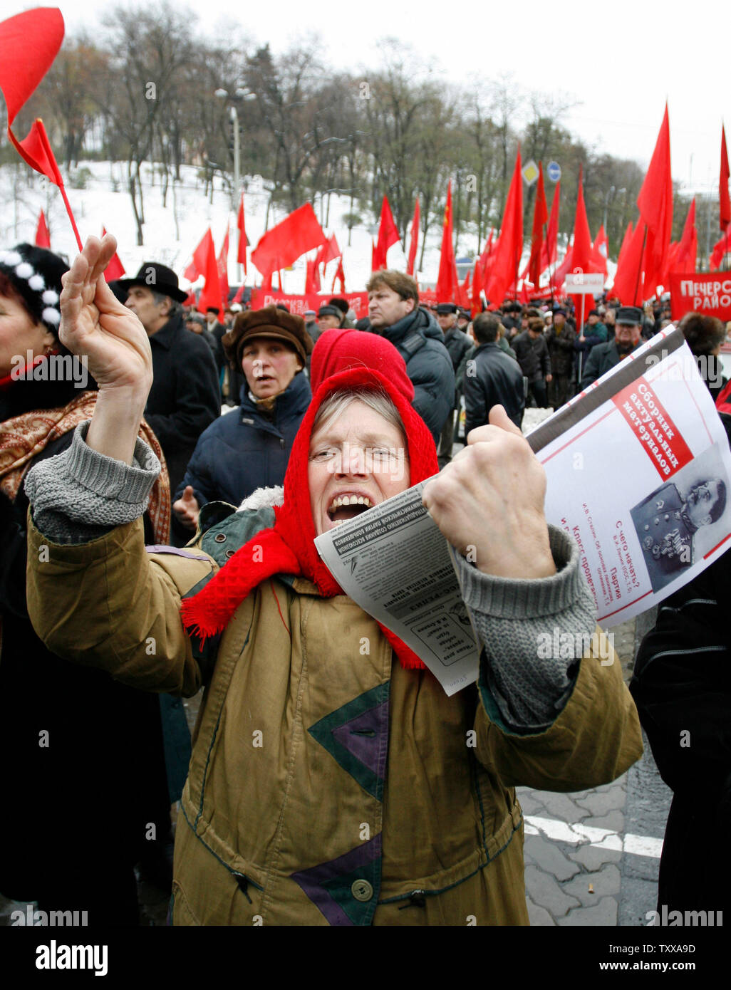 A woman waves a Soviet flag during a rally marking the 89th anniversary ...