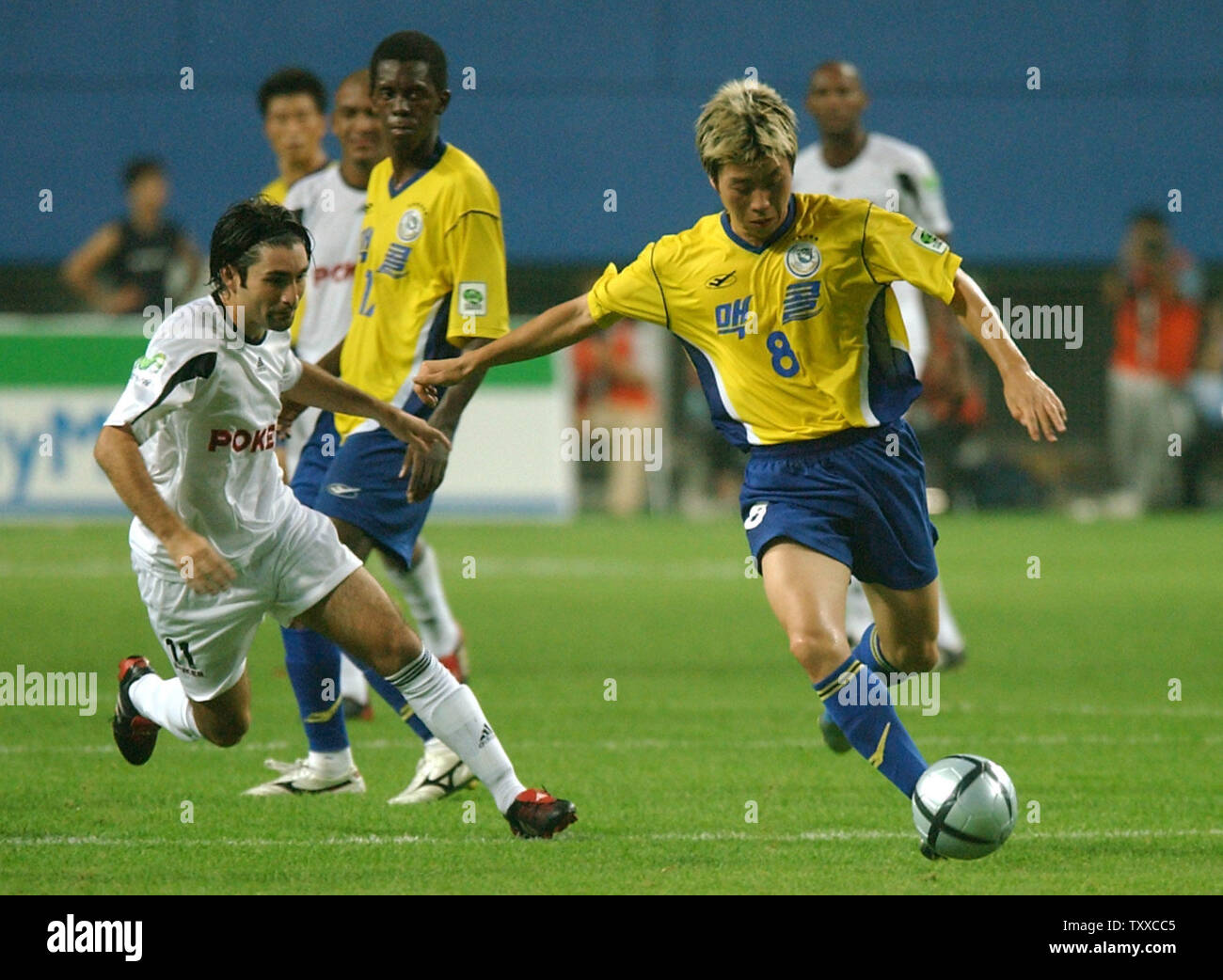 Kim Doon Hyun(MF,R) of the Seonnam Ilhwa, South Korea, dribbles a ball ...