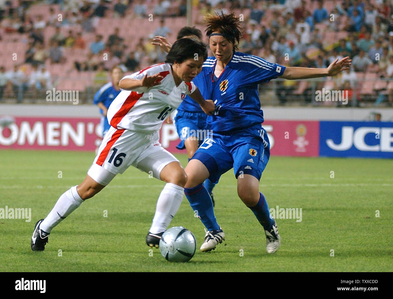Pak Kyong Sun(FW,L) of the North Korea, dribbles a ball to break the ...