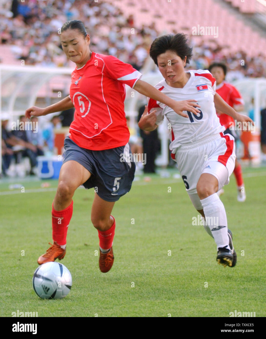 Hong Kyung Suk (DF, L) of the South Korea and Pak Kyong Sun (FW,R) of ...