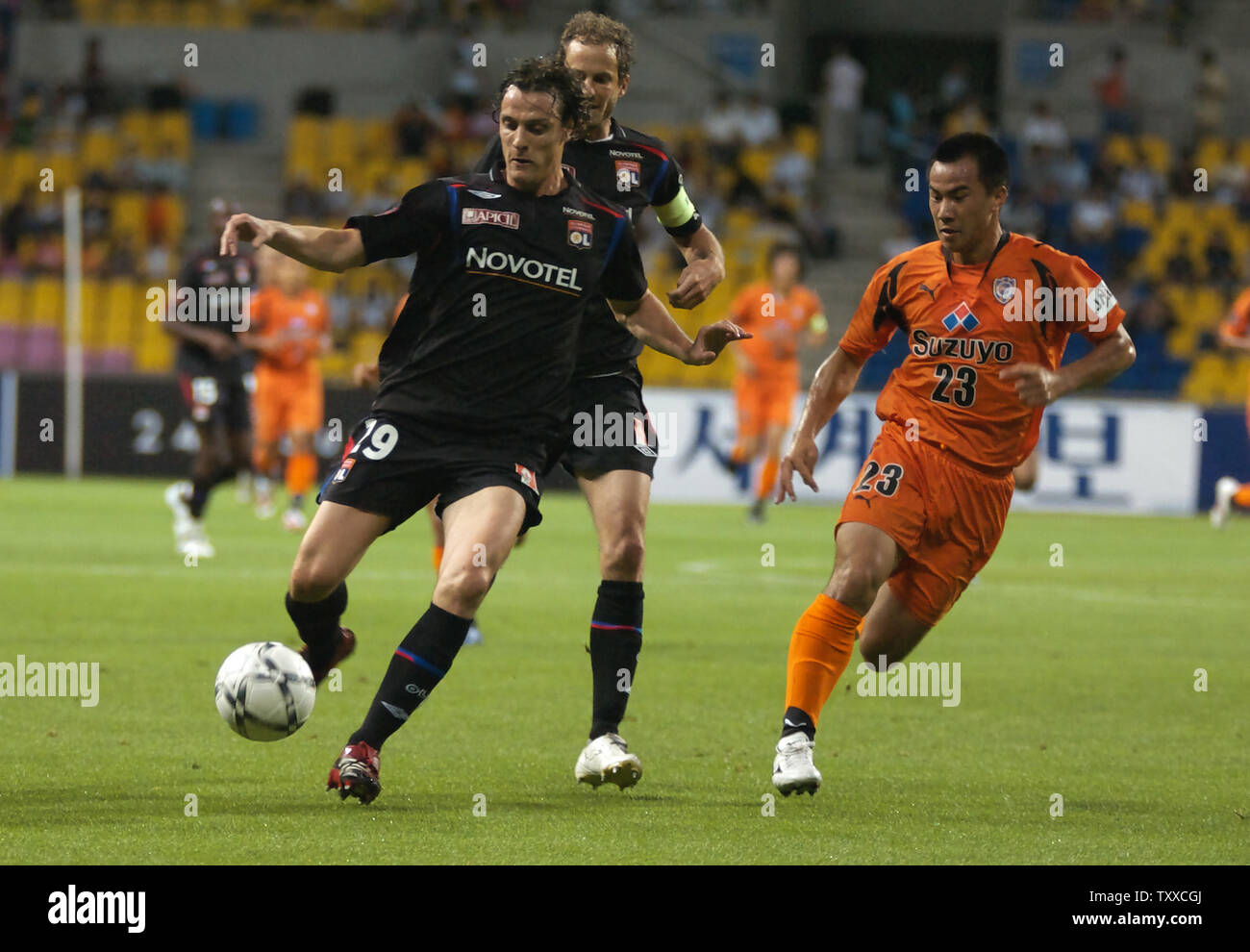 Sebastien Squillaci (L) of France's Olympique Lyon, sends the ball to ...