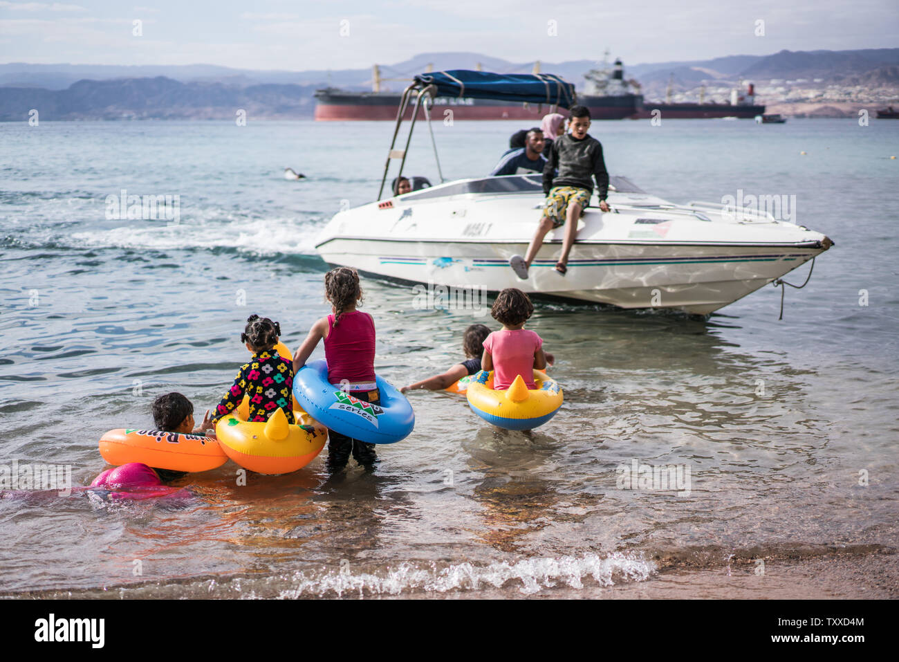 Local people on the beach, Aqaba, Jordan Stock Photo - Alamy