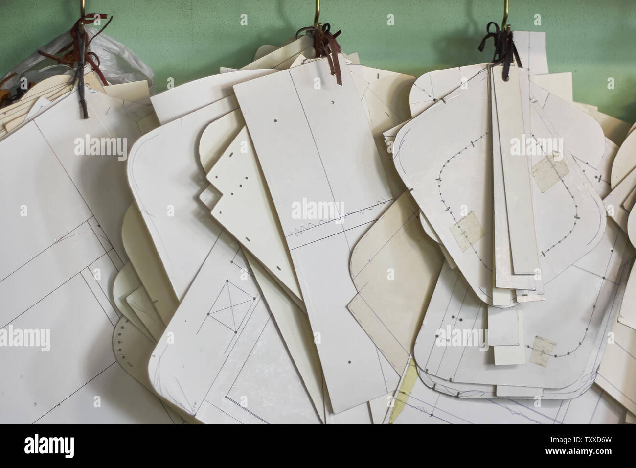 Professional tailor paper template set hanging on the wall in the ...