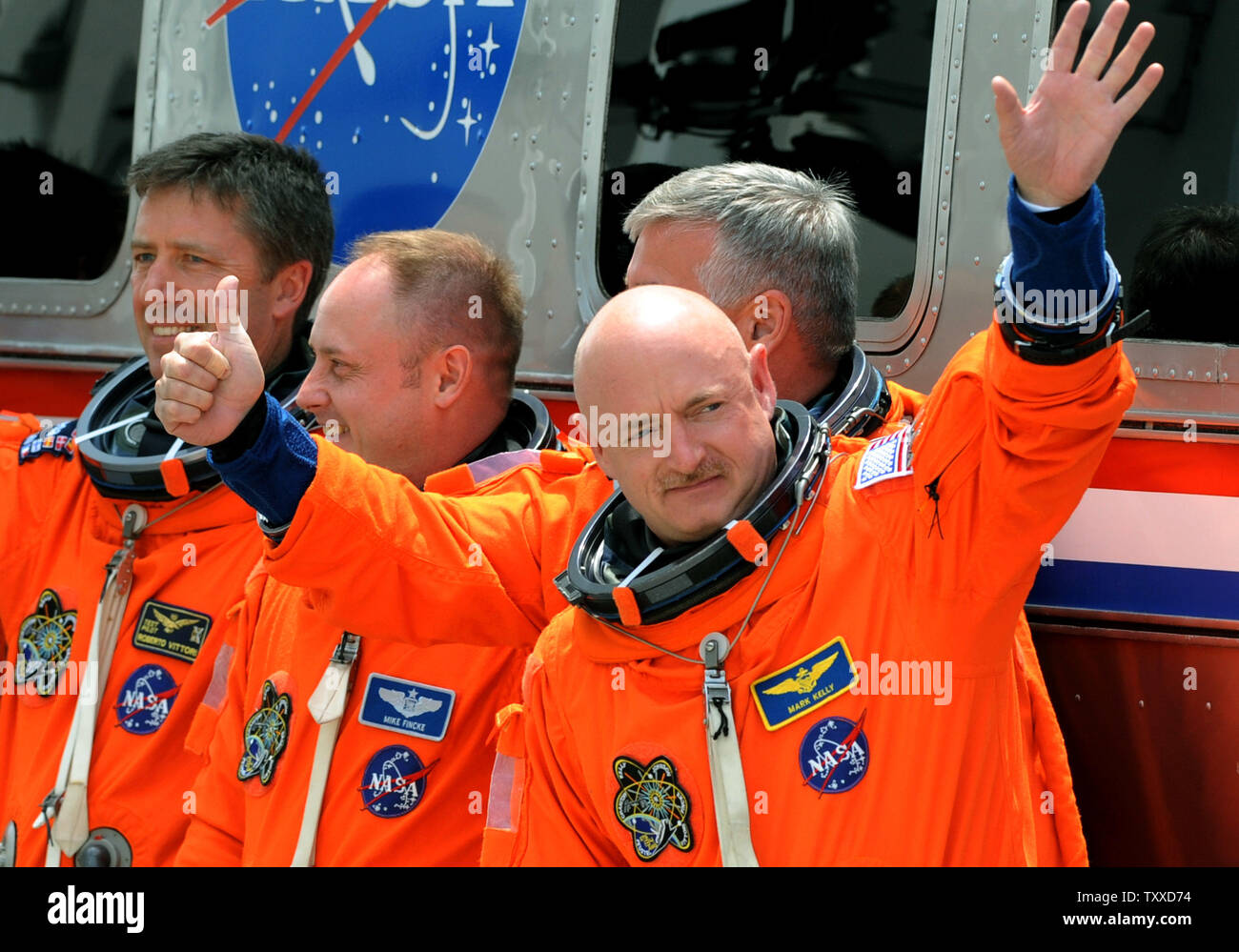 Space Shuttle Endeavour Commander Mark Kelly (right) waves after ...