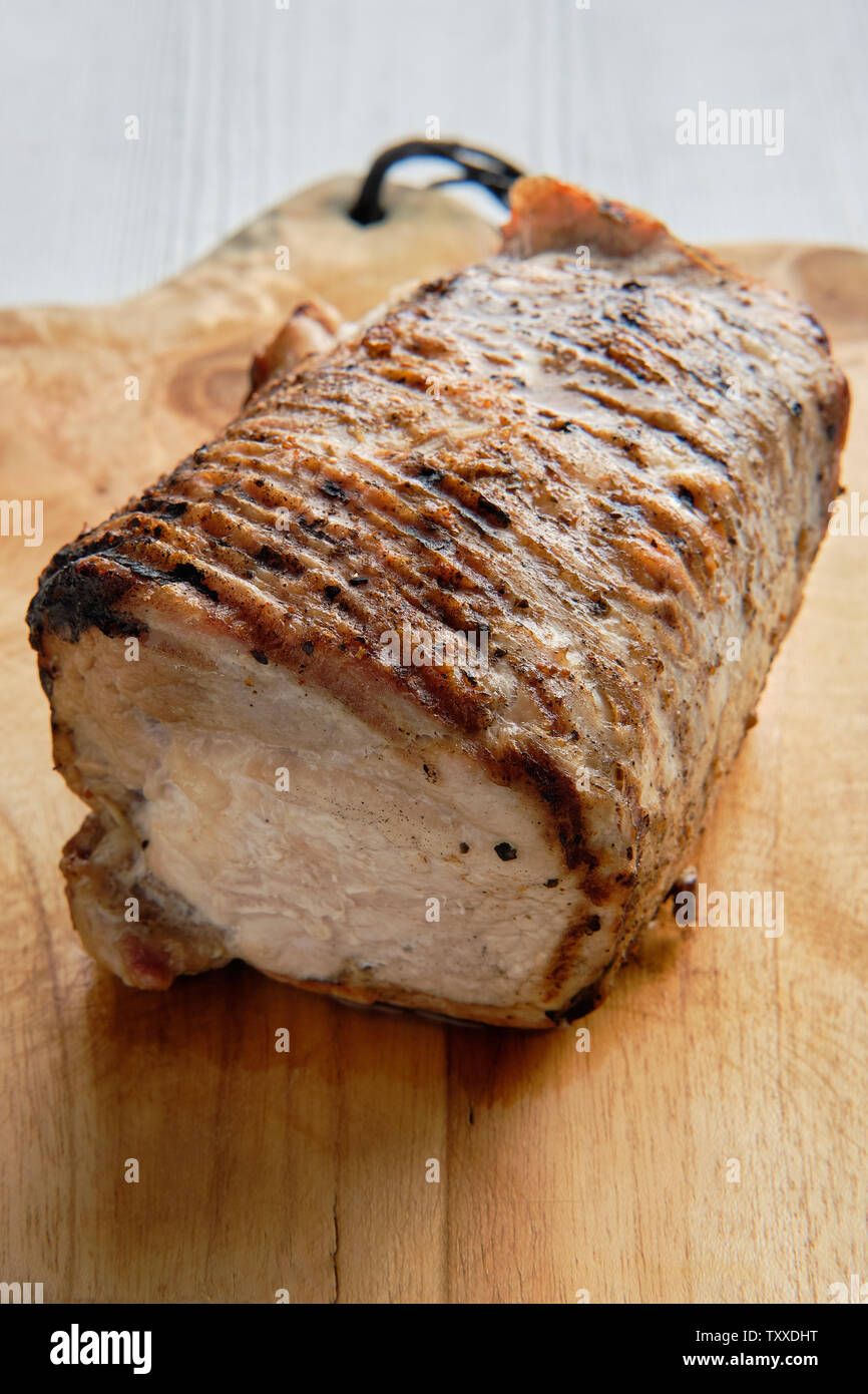 Baked peace of meat on cutting board Stock Photo - Alamy