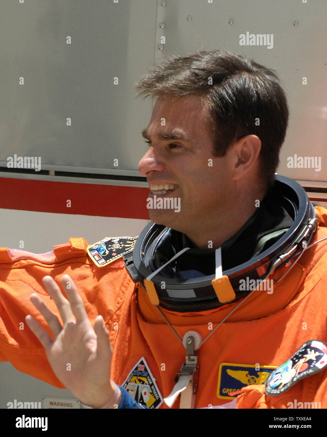 Astronaut and Mission Specialist Greg Chamitoff, departs from the crew quarters at the Kennedy ...