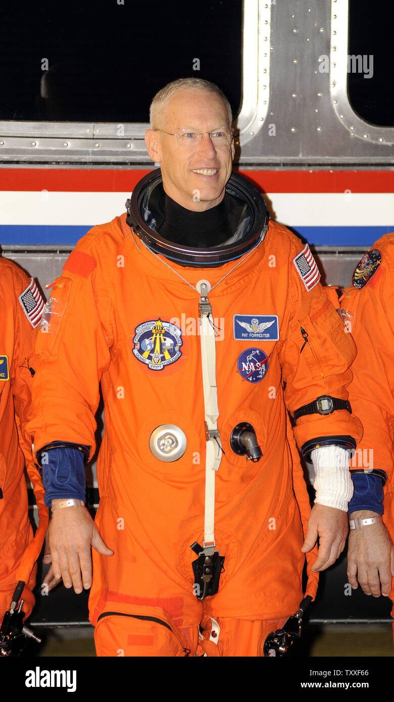 STS 128 Mission Specialist, Pat Forrester, waves to the media shortly ...