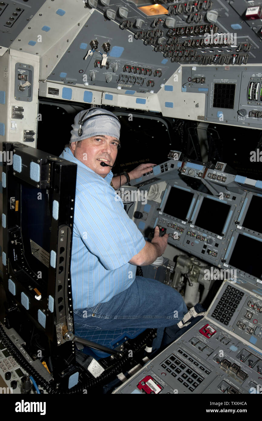 Spacecraft Operator William Powers sits in the Commander's seat of NASA ...