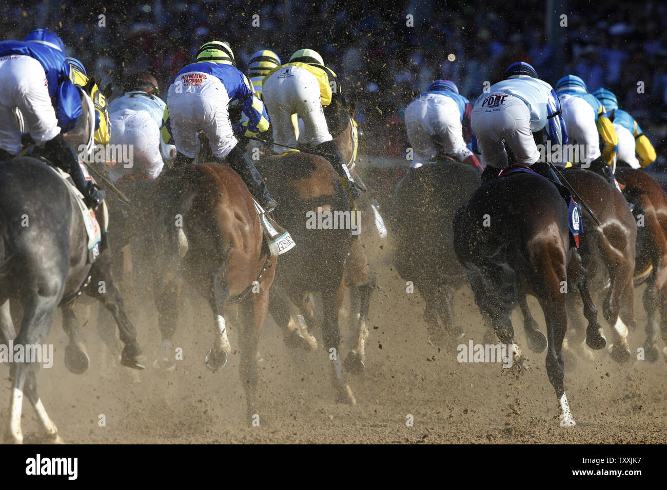 Horses round the first turn in the 141st running of the Kentucky Derby ...