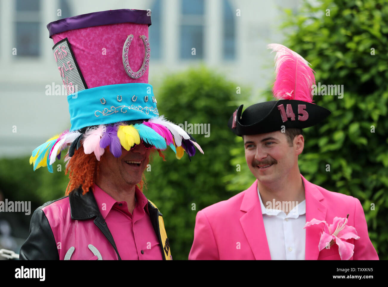 Horse racing fans show off their style as they wait for the running of ...