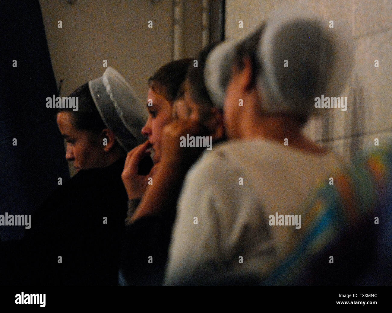 A group of Amish girls attend a prayer vigil for the victims of the ...