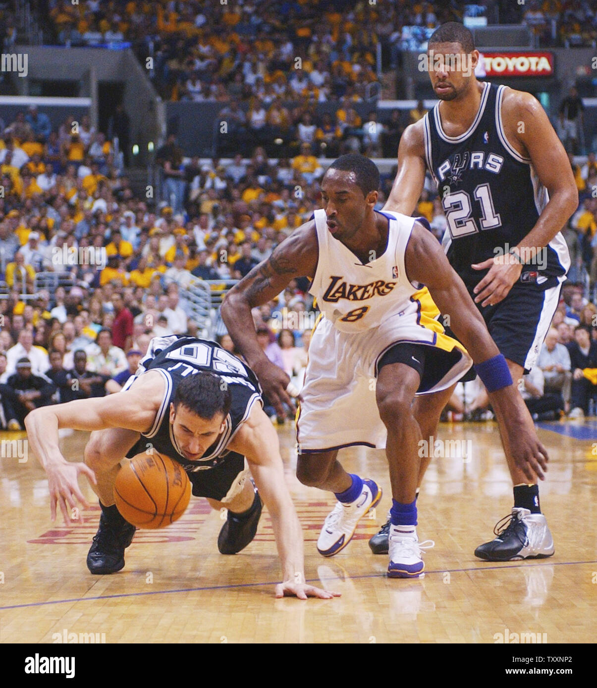San Antonio Spurs forward falls to the floor as Spurs center Tim Duncan ...