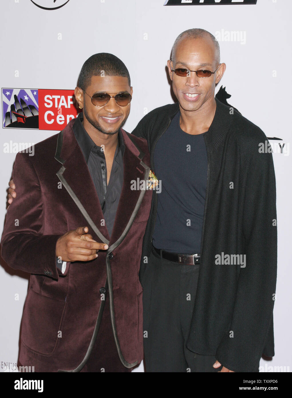 Singer Usher, left, and Ray Charles, Jr. pose for photographers before ...