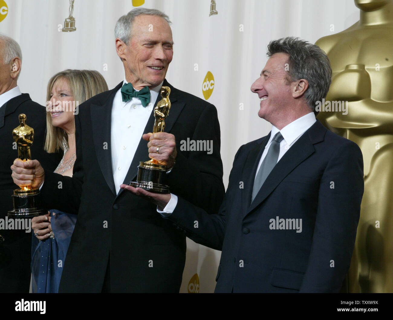 Clint Eastwood shows off the Oscars he won for Best Director and Best ...