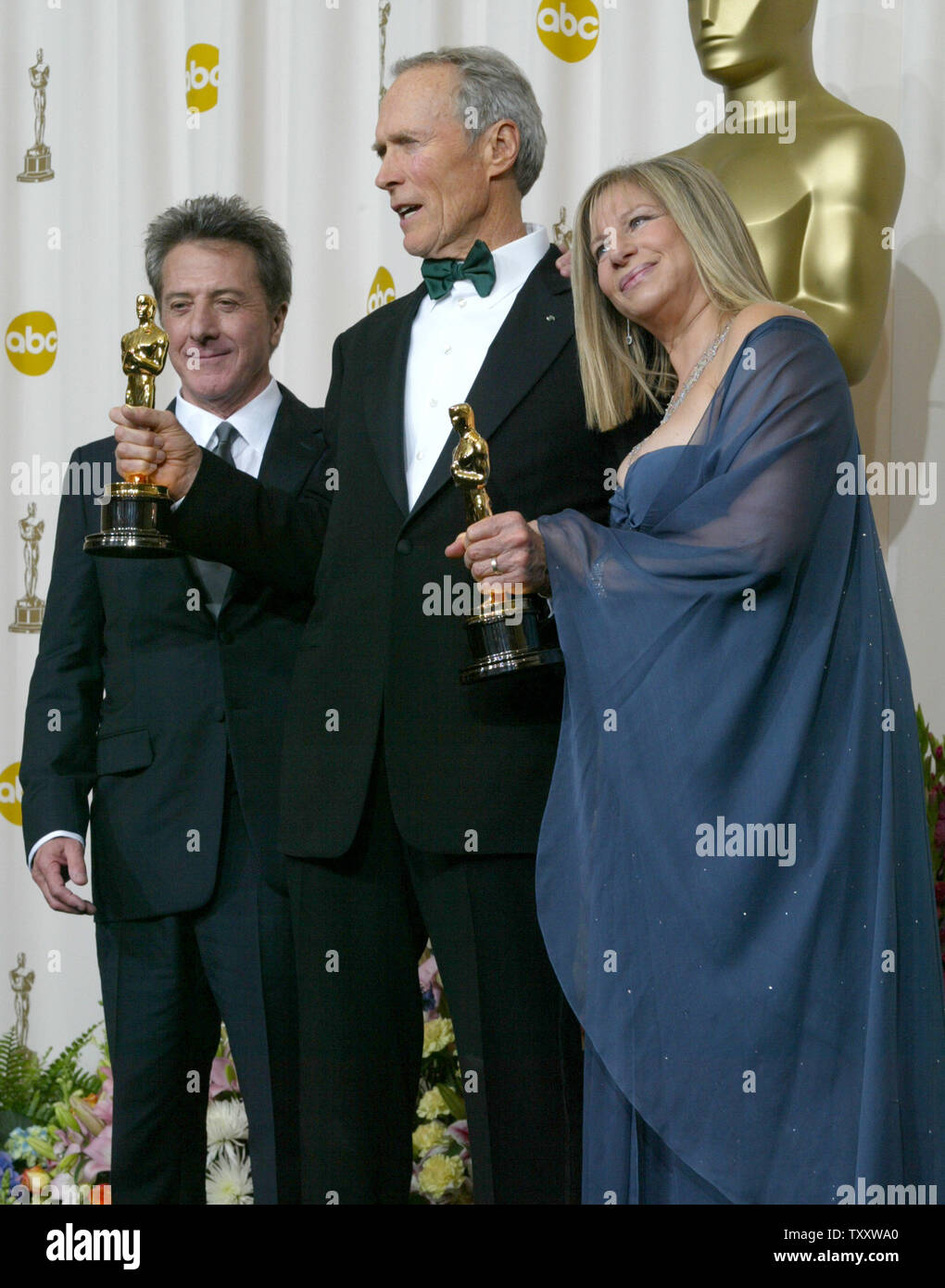 Clint Eastwood shows off the Oscars he won for Best Director and Best ...