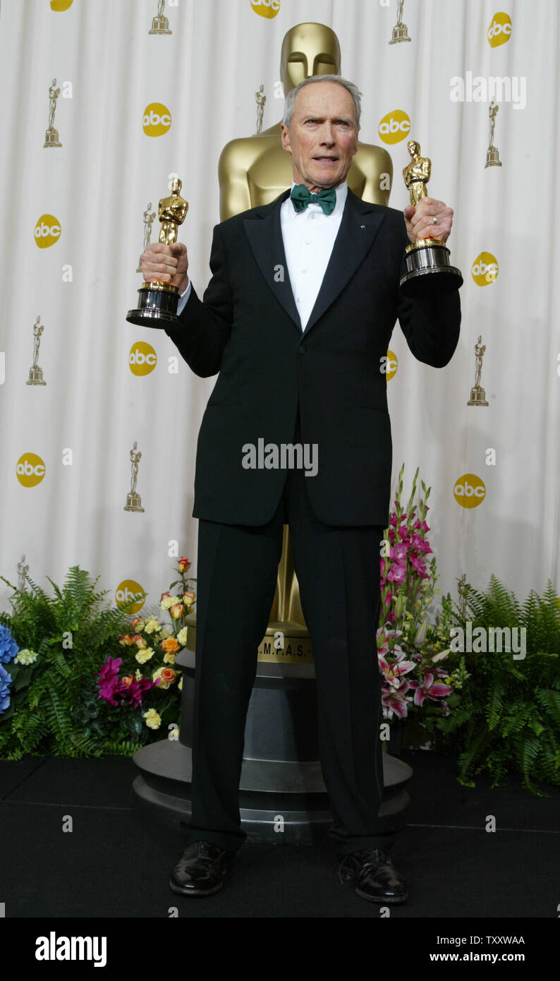 Clint Eastwood shows off the Oscars he won for Best Director and Best ...