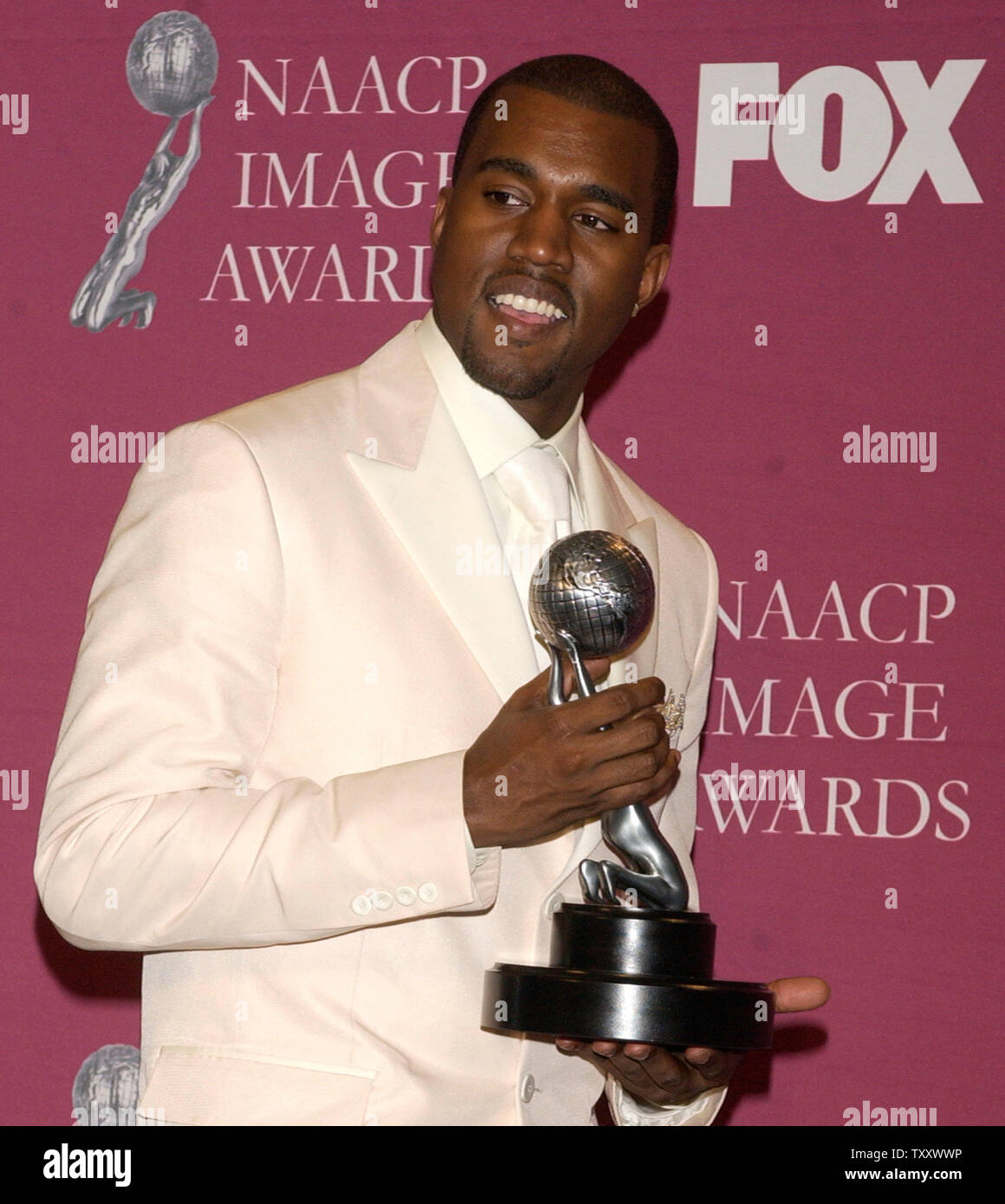 Singer Kanye West holds the award he won at the 36th NAACP Image Awards ...