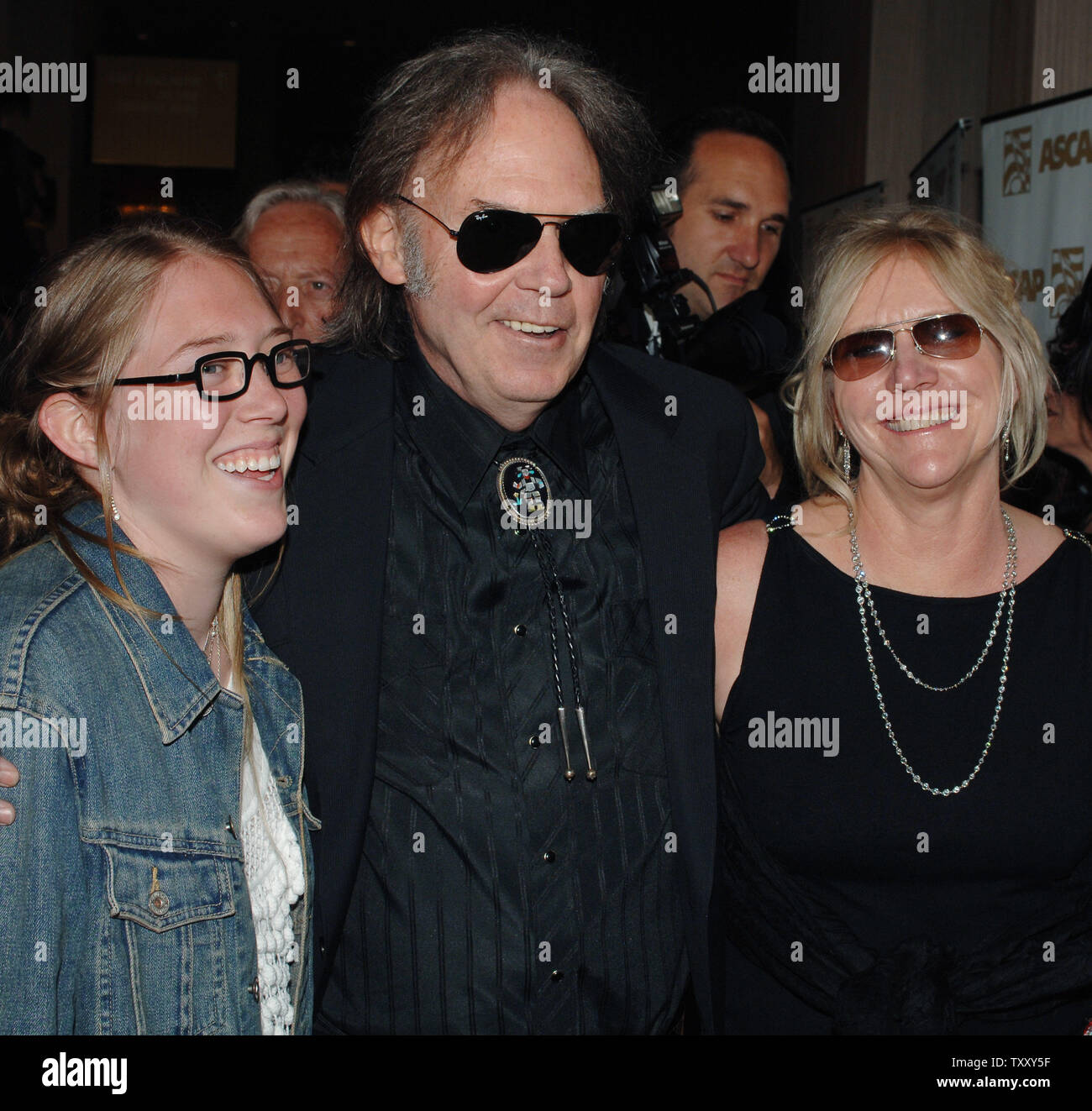Rock musician Neil Young (C) arrives with his wife Pegi (R) and their ...