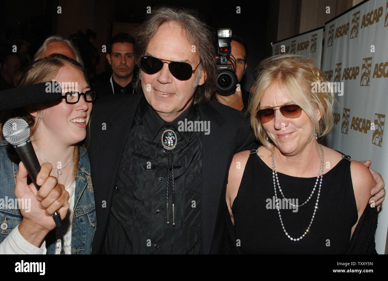 Rock musician Neil Young (C) arrives with his wife Pegi (R) and their ...