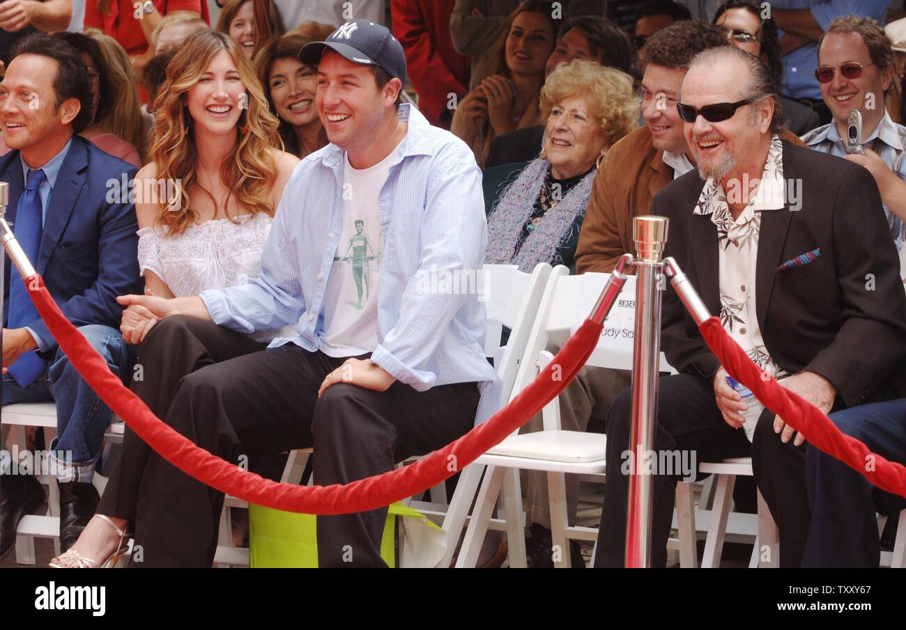 Actor Adam Sandler and his wife Jackie Titone (holding hands) laugh at ...