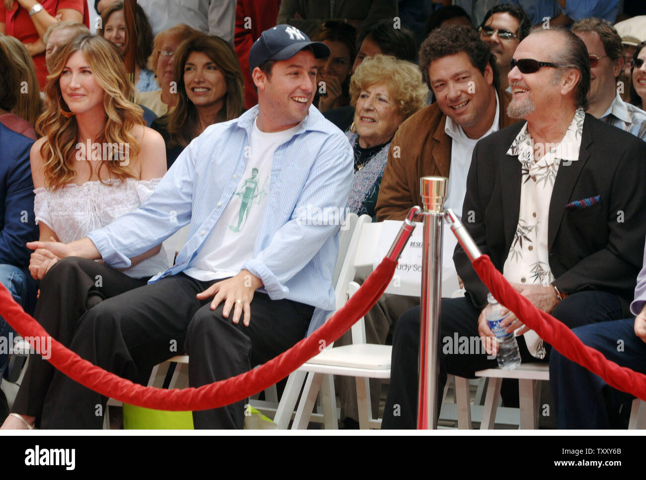 Actor Adam Sandler (C) and his wife Jackie Titone (L) react with actor ...