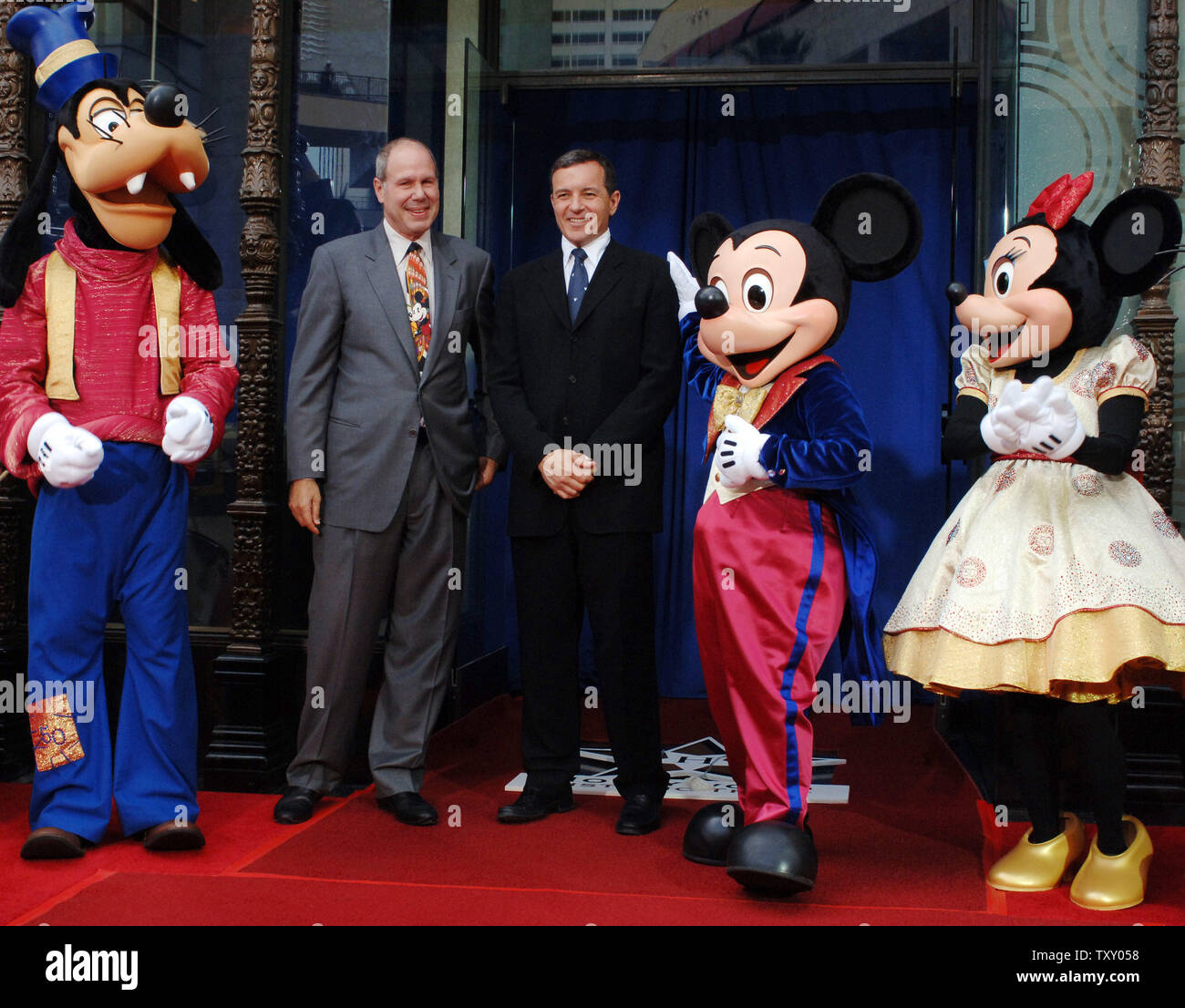 Michael Eisner (2nd L), chief executive officer of The Walt Disney ...