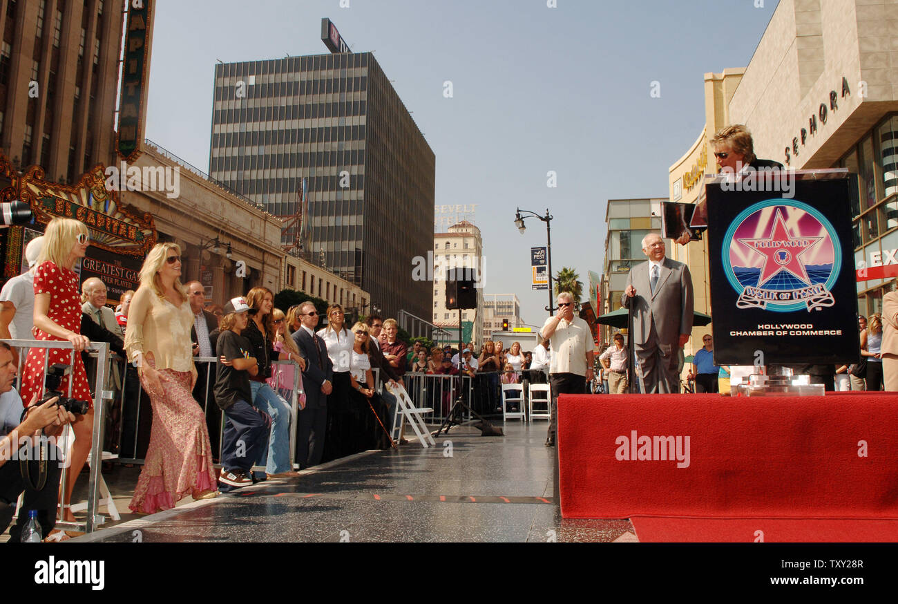 British rocker Rod Stewart thanks his fiance Penny Lancaster (2-R) as ...