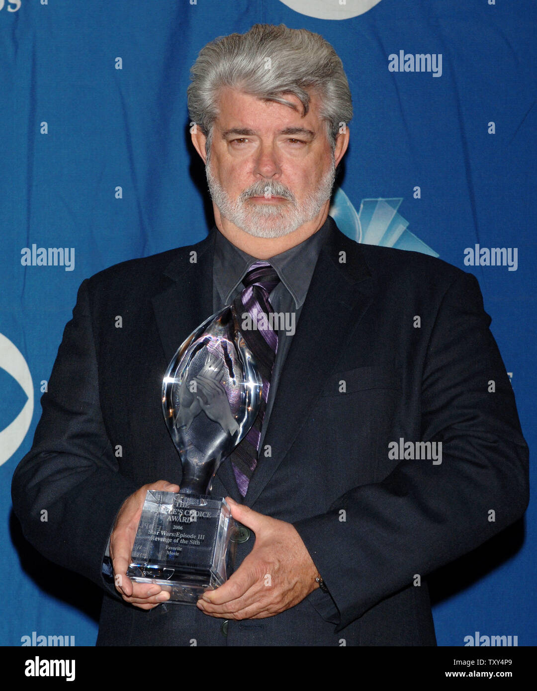 "Star Wars" creator George Lucas holds his award after winning for ...