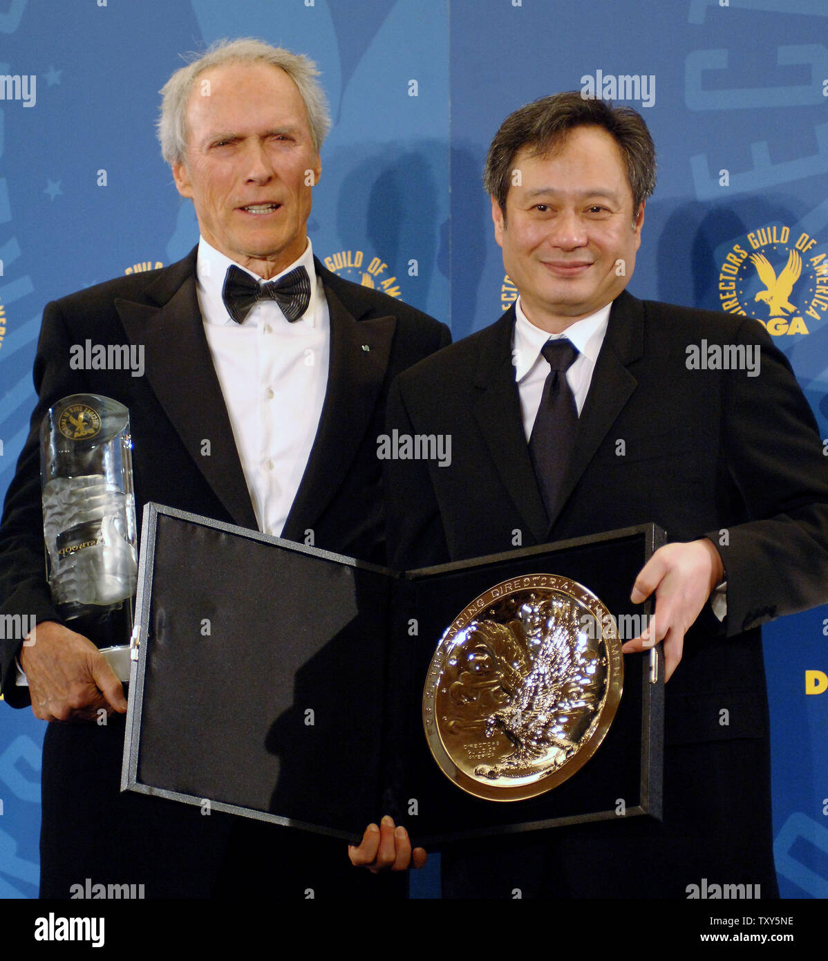 Clint Eastwood (L) holds his DGA Lifetime Achievement Award as he poses ...