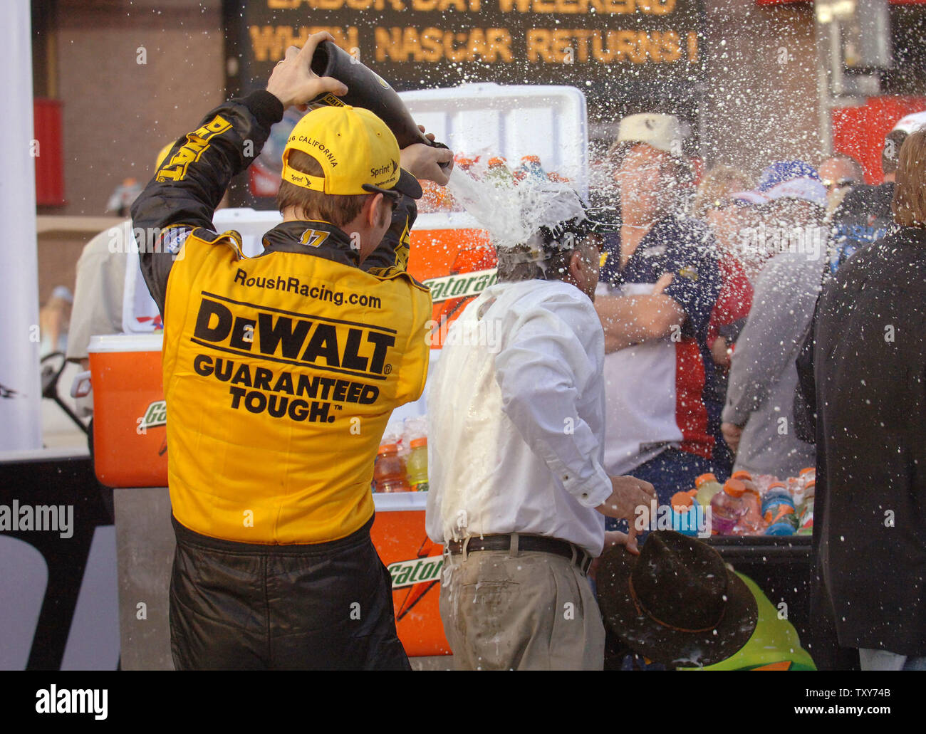 Matt Kenseth (L) showers car owner Jack Roush with champagne following ...