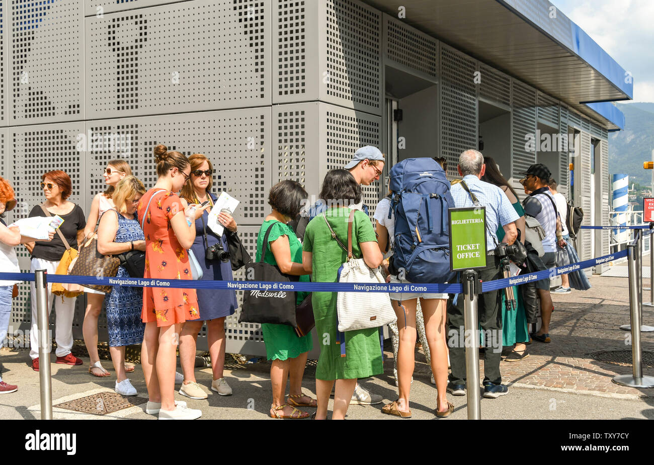 COMO, ITALY - JUNE 2019: Crowd of people queuing for ferry tickets at ...