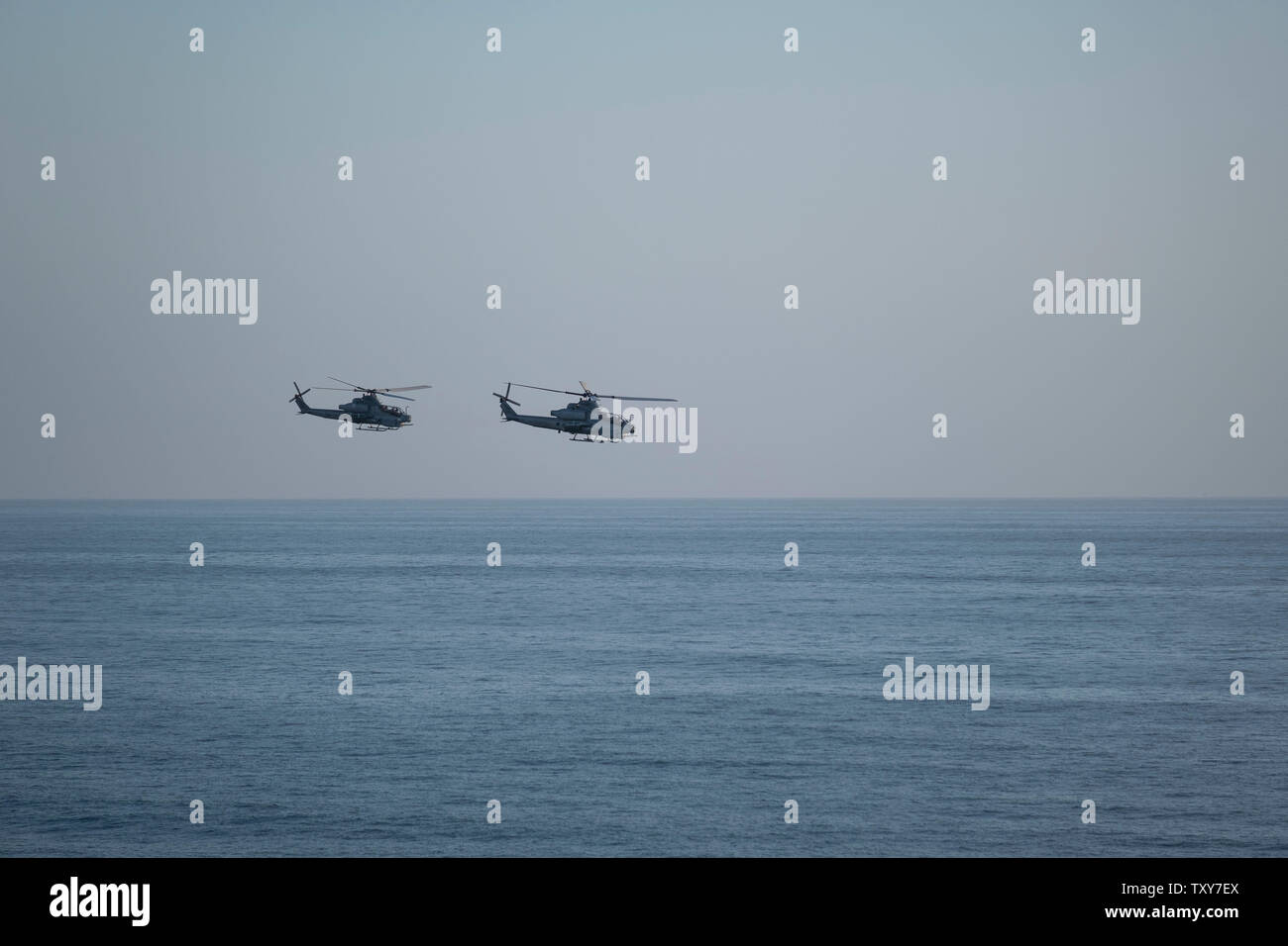 Military Helicopters fly in tandem above the ocean Stock Photo - Alamy