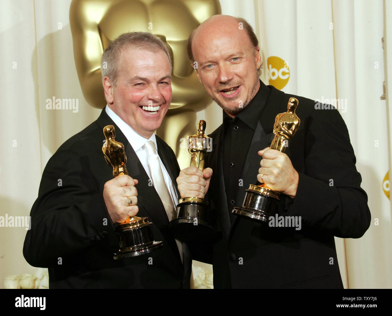Paul Haggis and Bobby Moresco pose with their Oscars for best ...