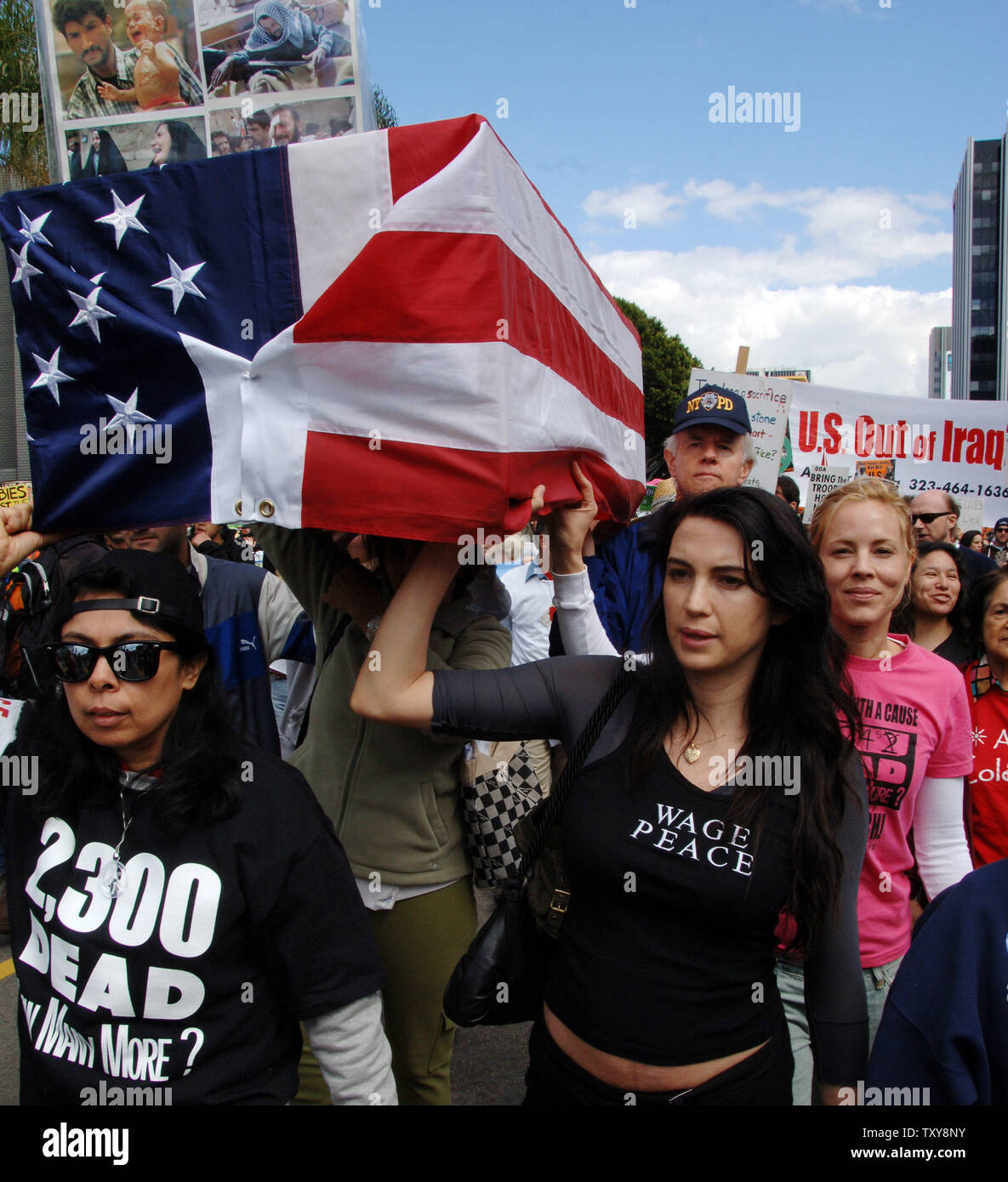 Anti-war demonstrators, including actress Maria Bello (R) march in ...