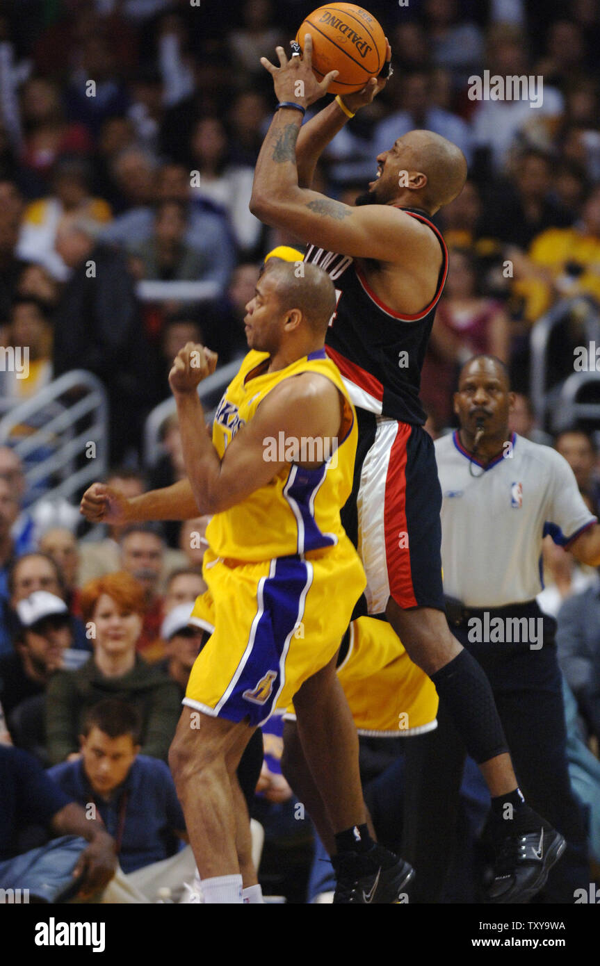 Portland Trail Blazers' forward Brian Skinner (#54 is fouled by Los ...