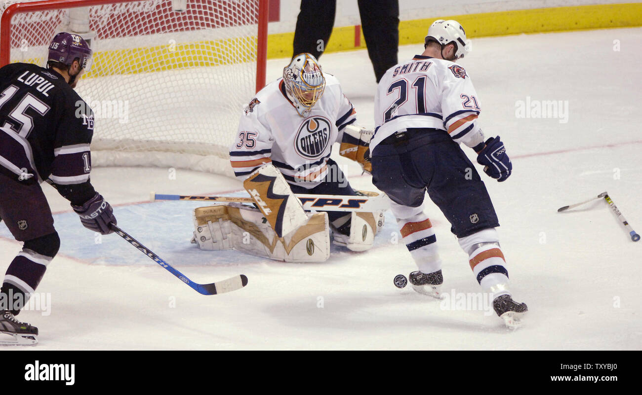 Oilers goal tender Dwayne Roloson blocks a shot on goal by the Mighty ...
