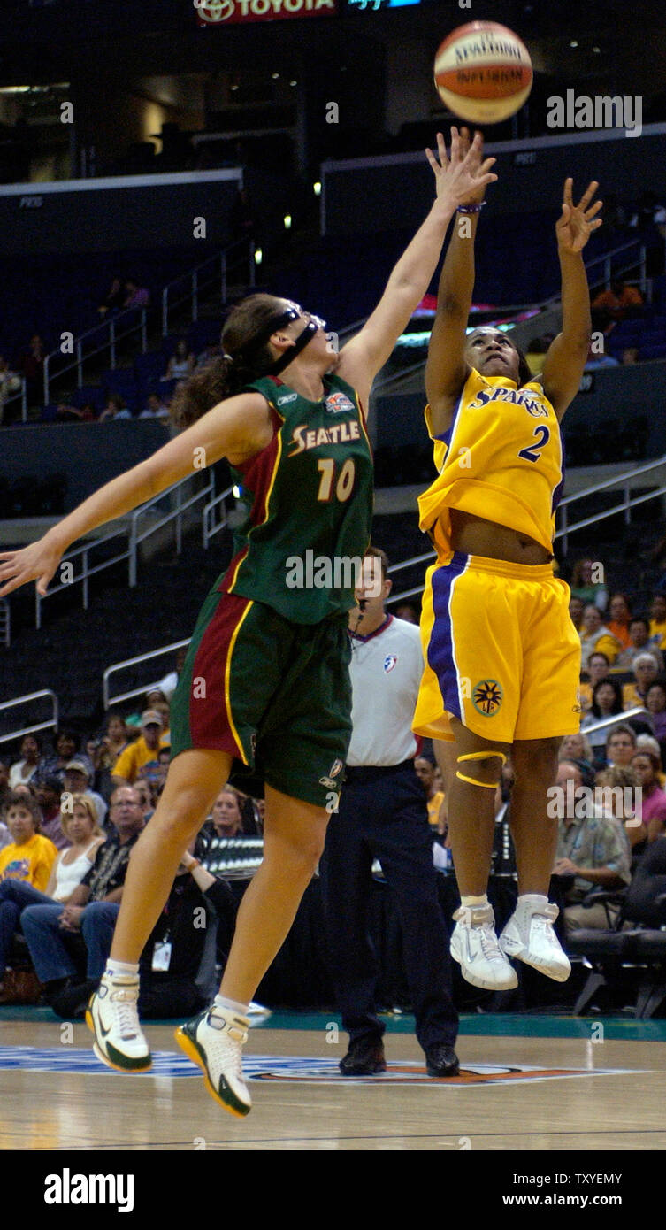 Los Angeles Sparks' Temeka Johnson (R) scores over Seattle Storm's Sue ...