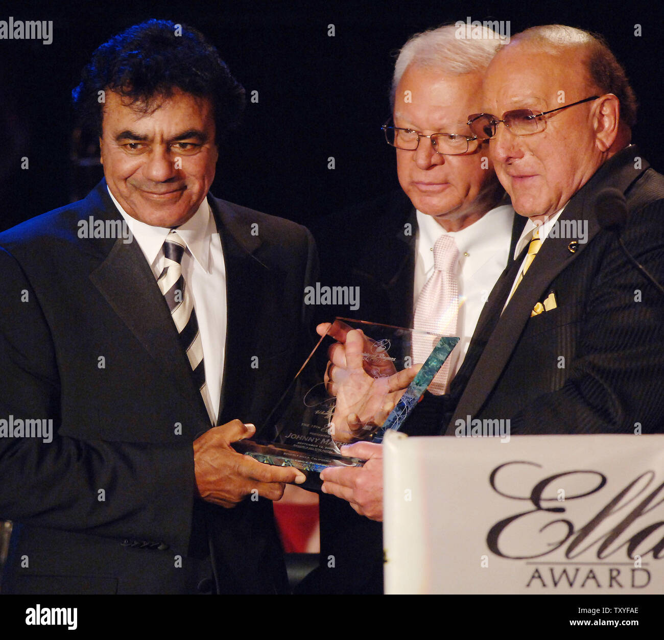 J Records founder Clive Davis (R) presents singer Johnny Mathis (L ...