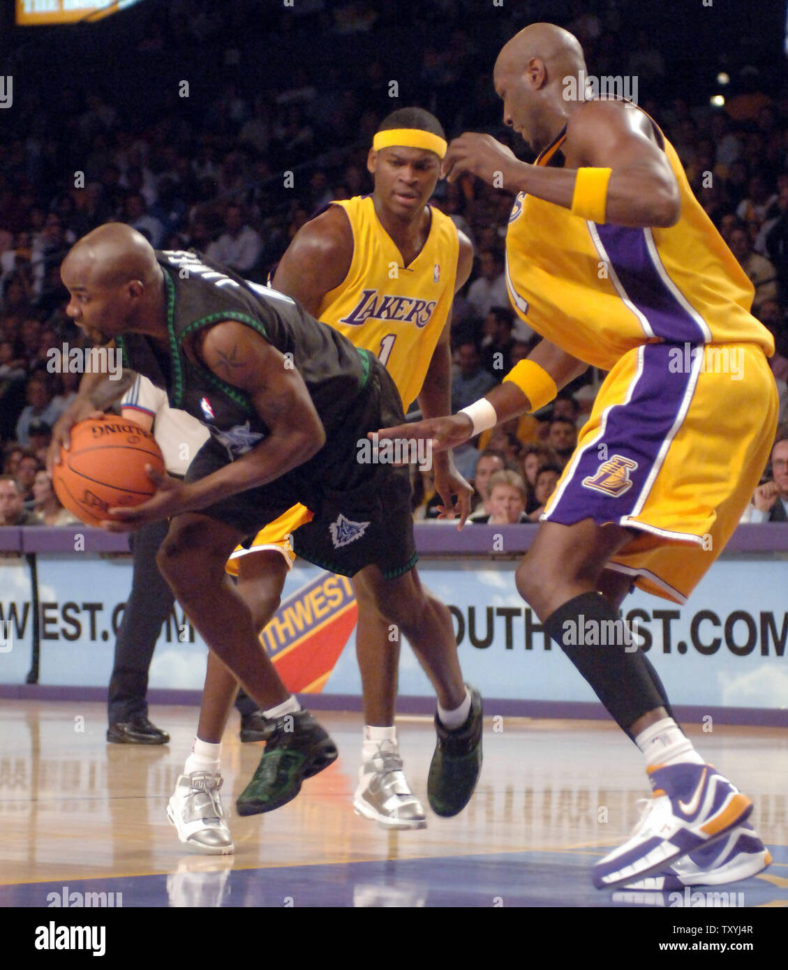 Minnesota Timberwolves' Ricky Davis stumbles after splitting the ...