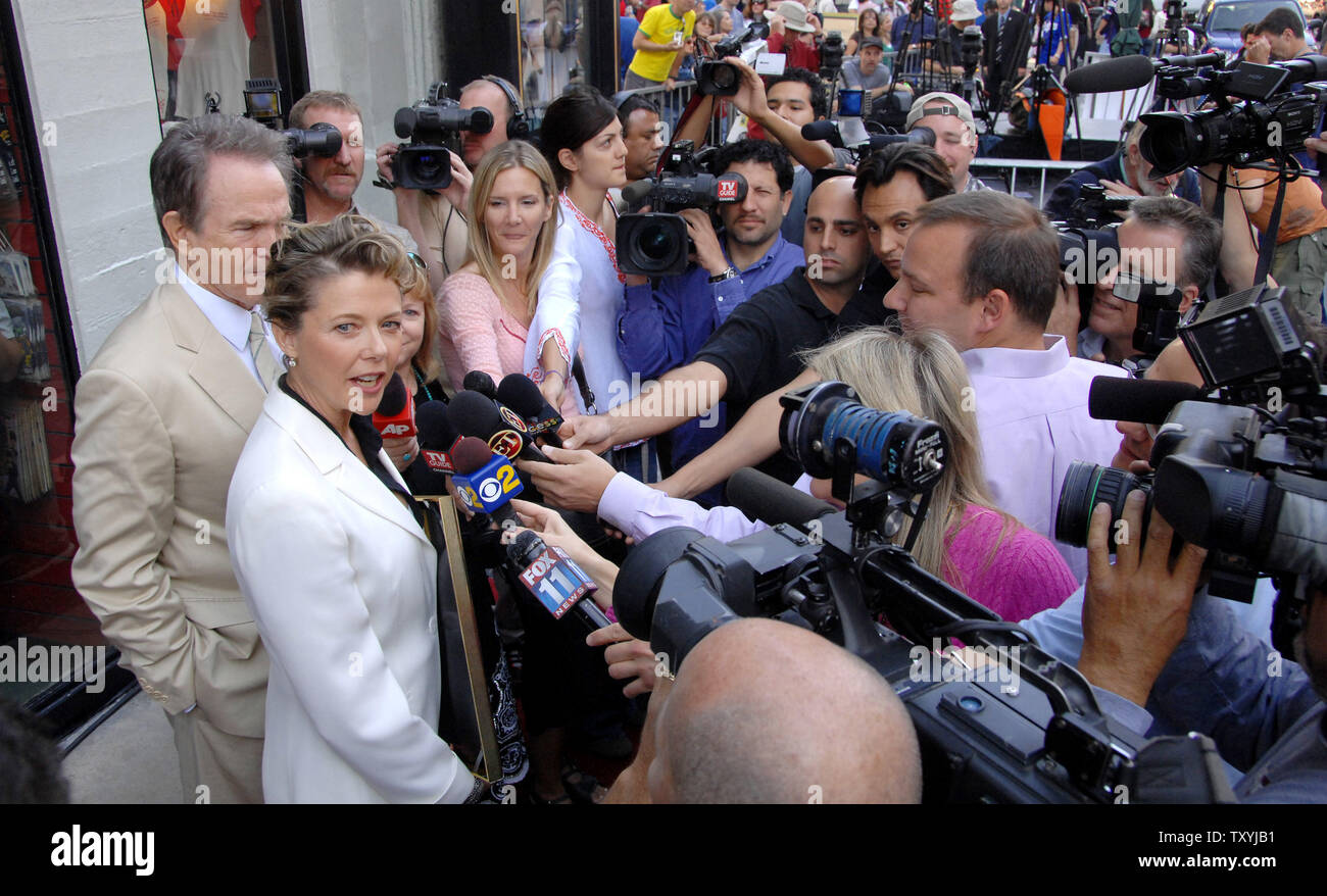Actress Annette Bening and her husband, actor Warren Beatty, speak with ...