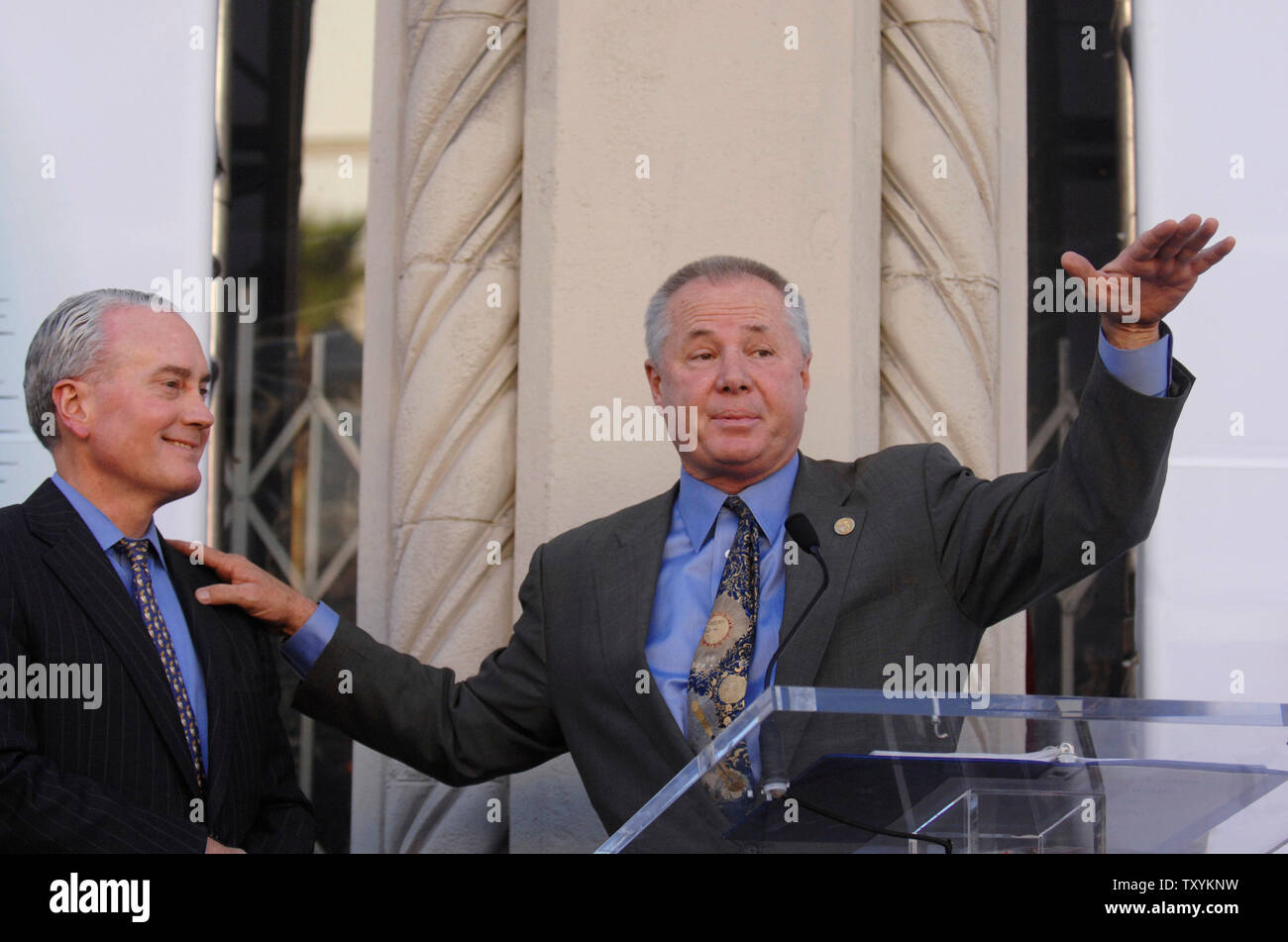 Los Angeles Times publisher David Hiller (L) looks on as City ...