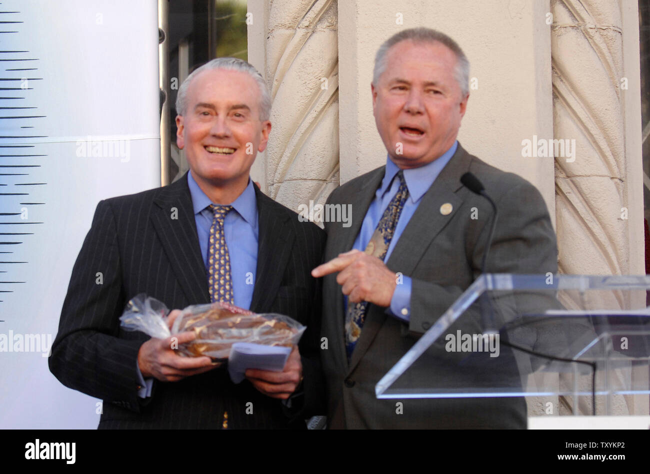 Los Angeles Times publisher David Hiller (L) looks on as City ...