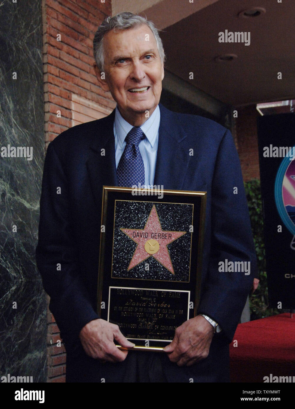 David Gerber, an Emmy and Peabody Award winner, holds a replica plaque ...