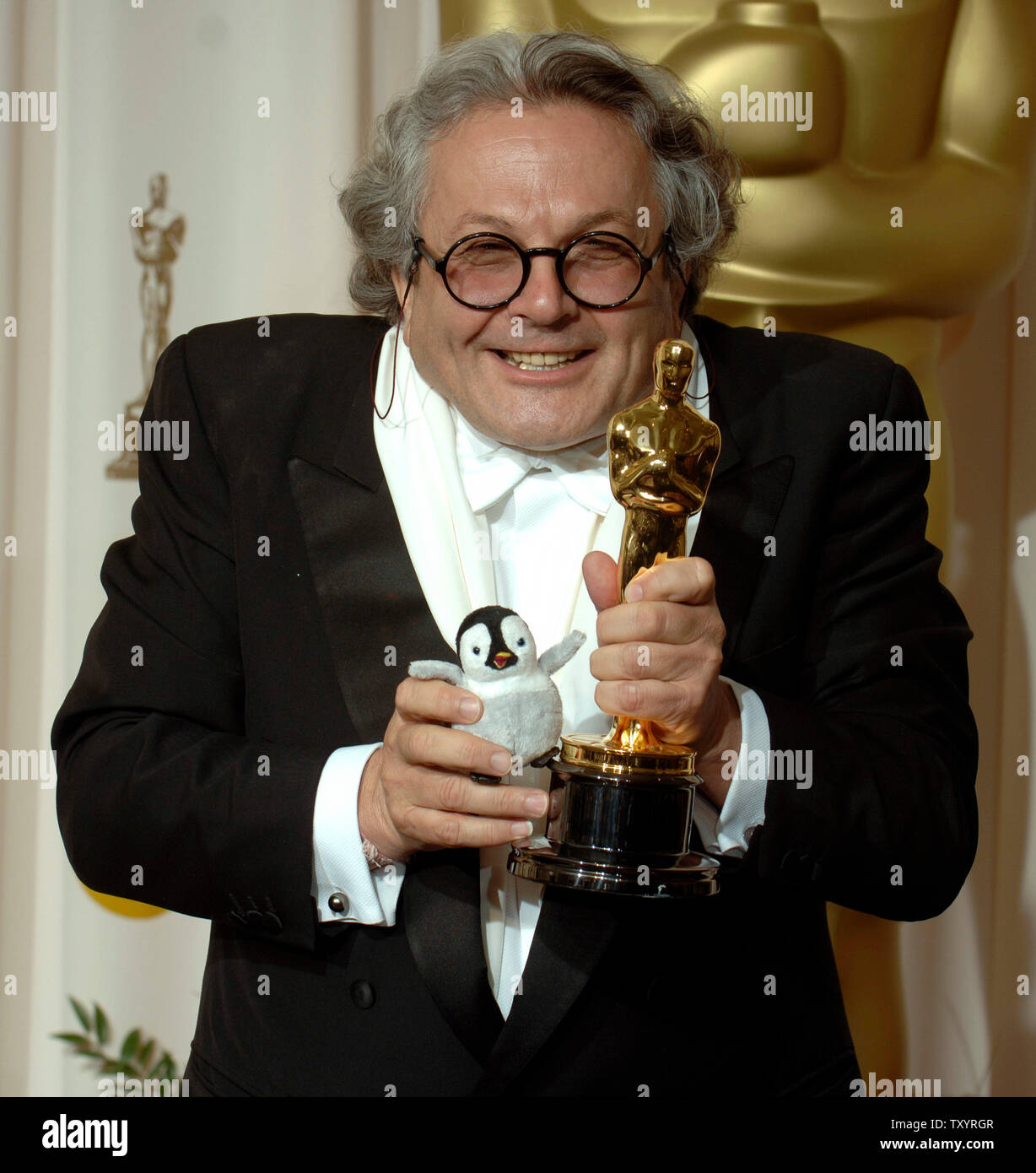 George Miller poses the Oscar he received for the best Animated Feature ...
