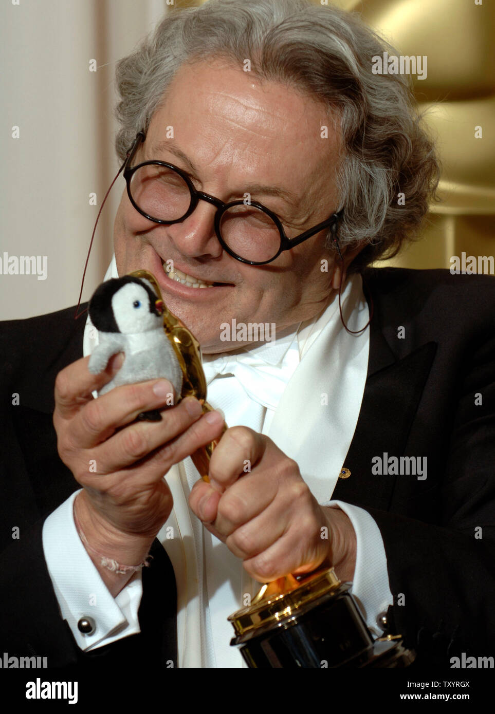 George Miller poses the Oscar he received for the best Animated Feature ...